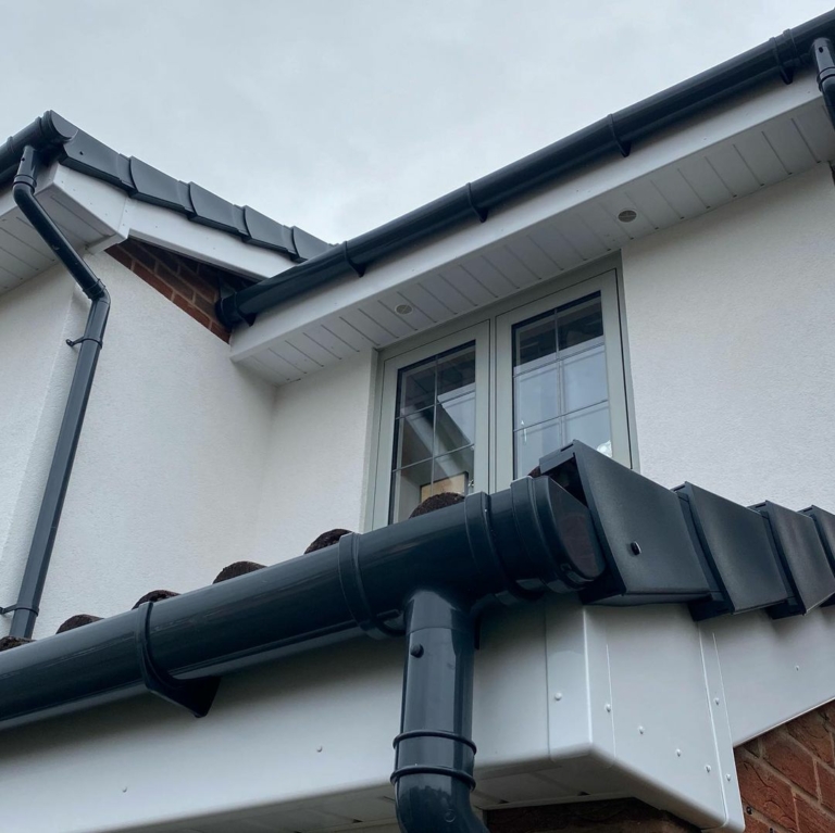 Anthracite Grey guttering, white fascia boards and grey dry verge ...